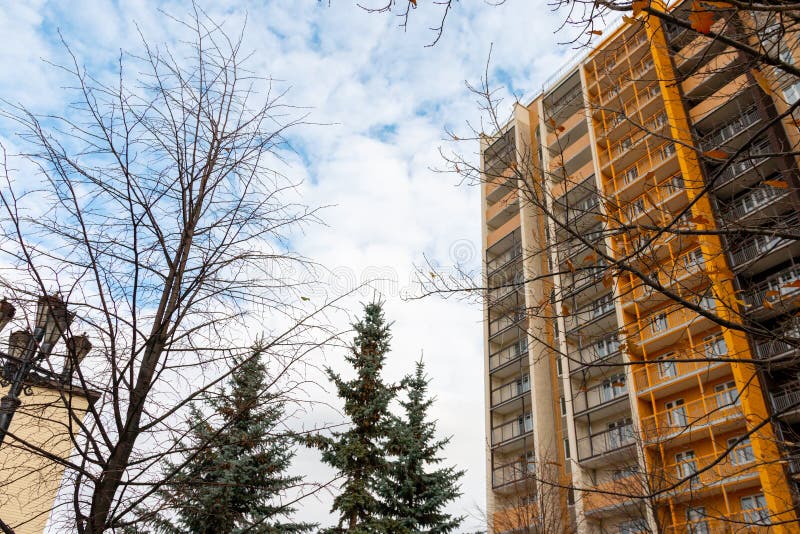 Trees Standing in Front of a Multi-storey Building Stock Image - Image ...