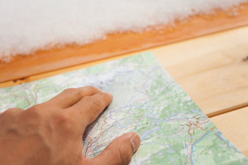 A Trekker Checking a Map during His Trip Stock Photo - Image of route ...