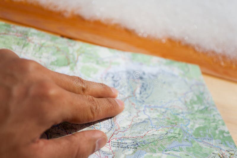 A Trekker Checking a Map during His Trip Stock Photo - Image of ...