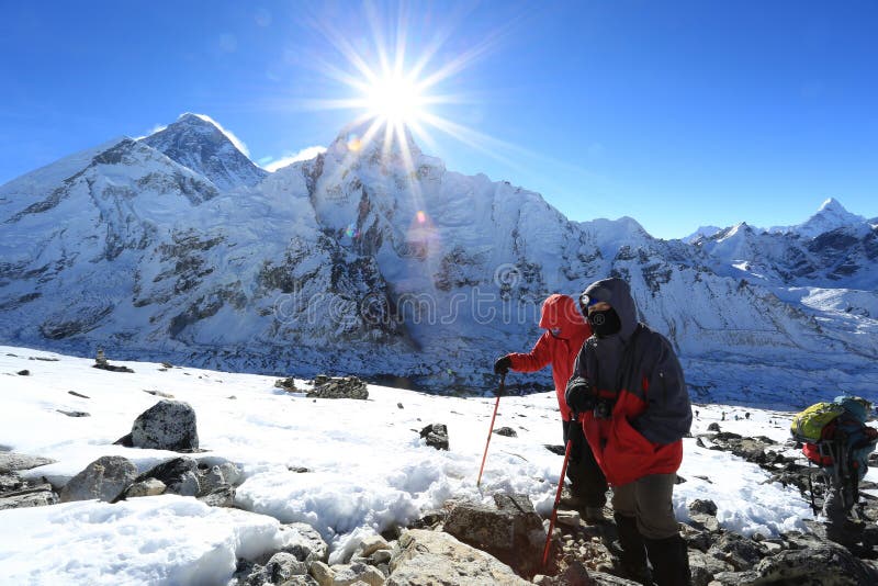 Trekker and Flare Over Nuptse Summit beside of Everest Stock Image ...