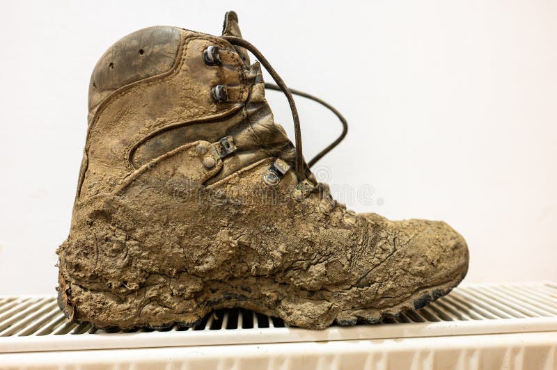 Trekking Boots Dirty in the Mud Drying on the Radiator Stock Photo ...