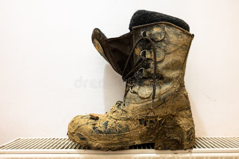 Trekking Boots Dirty in the Mud Drying on the Radiator Stock Photo ...