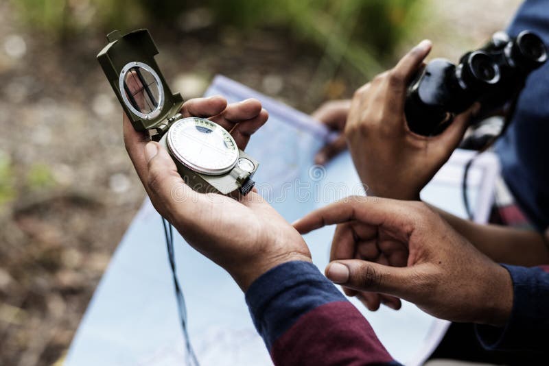 Trekking Couple Using Map and Compass in a Forest Stock Image - Image ...