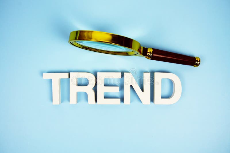 Trend Word with Magnifying Glass Top View on Blue Background Stock ...