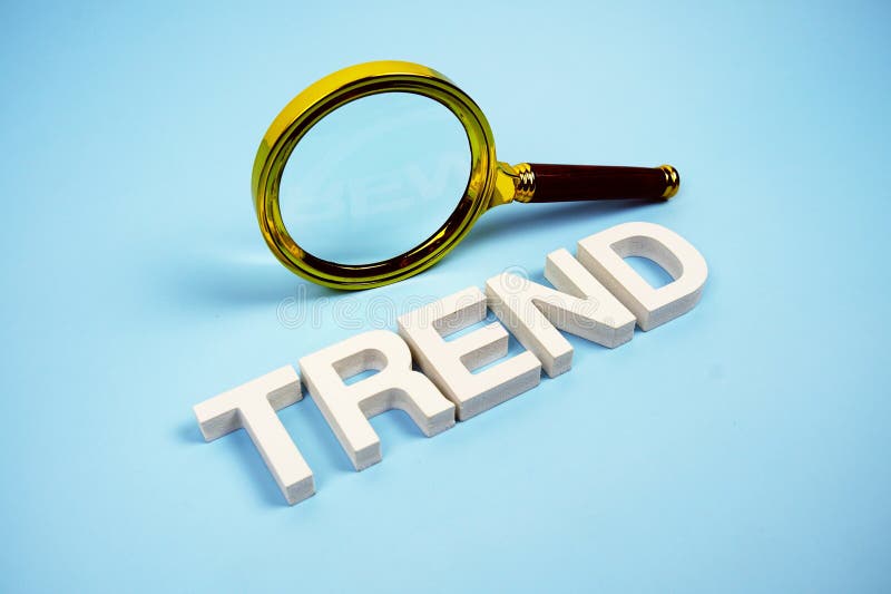 Trend Word with Magnifying Glass Top View on Blue Background Stock ...
