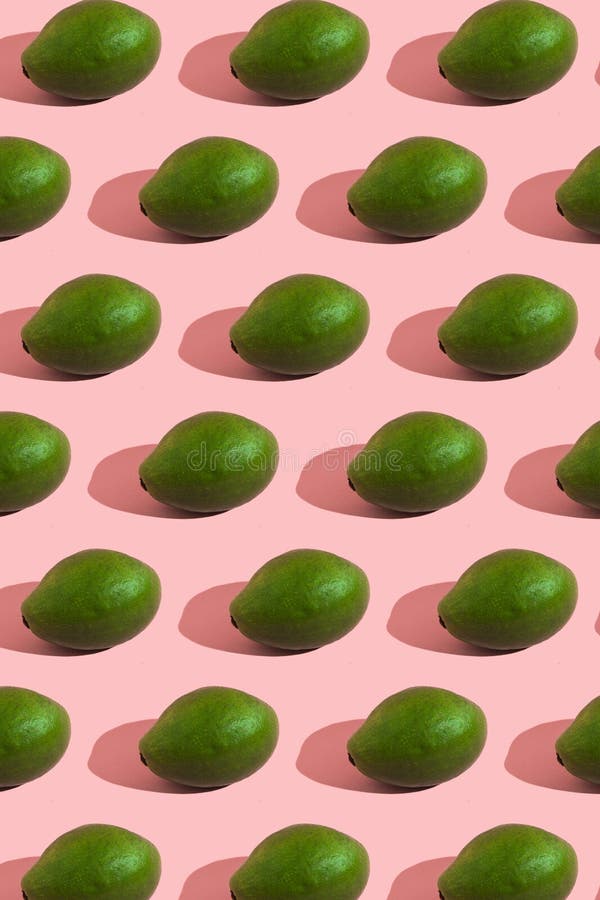 Trending Style Pattern of a Whole Green Avocado on a Pink Background ...