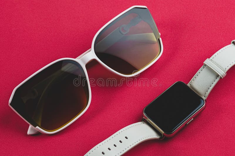 Trendy Composition of Sunglasses and Smart Watch on a Red Background ...