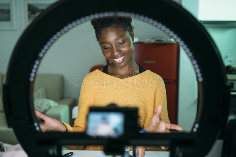In a Trendy Indoor Setting, a Vlogger is Utilizing a Ring Light for ...