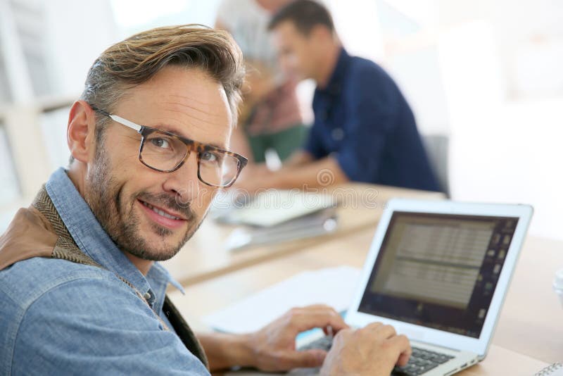Trendy Man Working on Laptop at Office Stock Image - Image of business ...