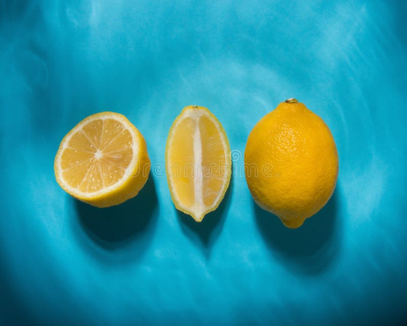 Trendy Summer Fruit on a Water Wave Blue Background. Fresh Yellow Lemon ...