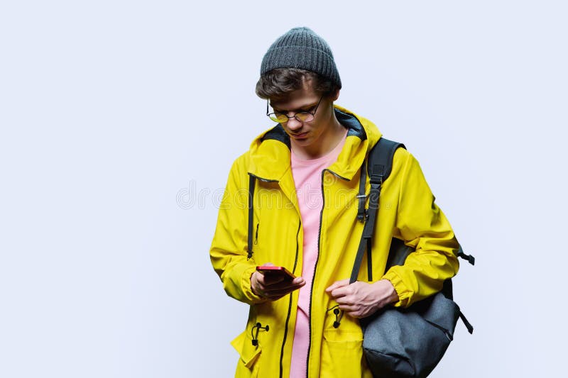 Trendy Young Male in Yellow Jacket Hat Using Smartphone on White ...