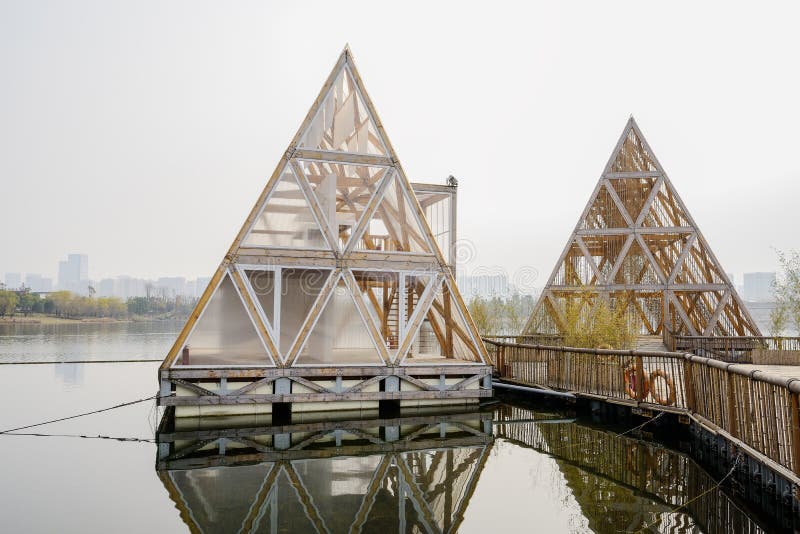 Triangle Cabins and Float Bridge in Lake of Sunny Hazy Winter Editorial ...