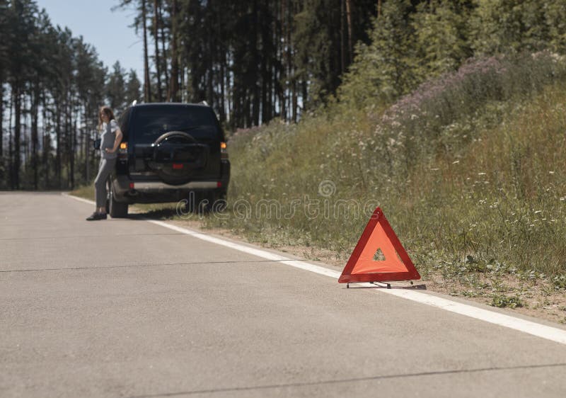Triangle Caution Sign on Roadside after Car Breakdown and Woman Driver ...
