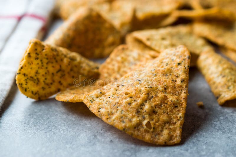 Triangle Corn Chips with Poppy Seeds Stock Photo - Image of salty ...