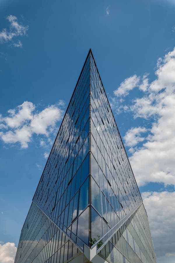 Triangle Glass Building with Reflection of Clouds Stock Photo - Image ...