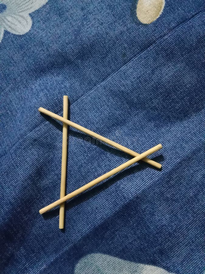 Triangle Make from Stick in Blue Background Stock Photo - Image of ...