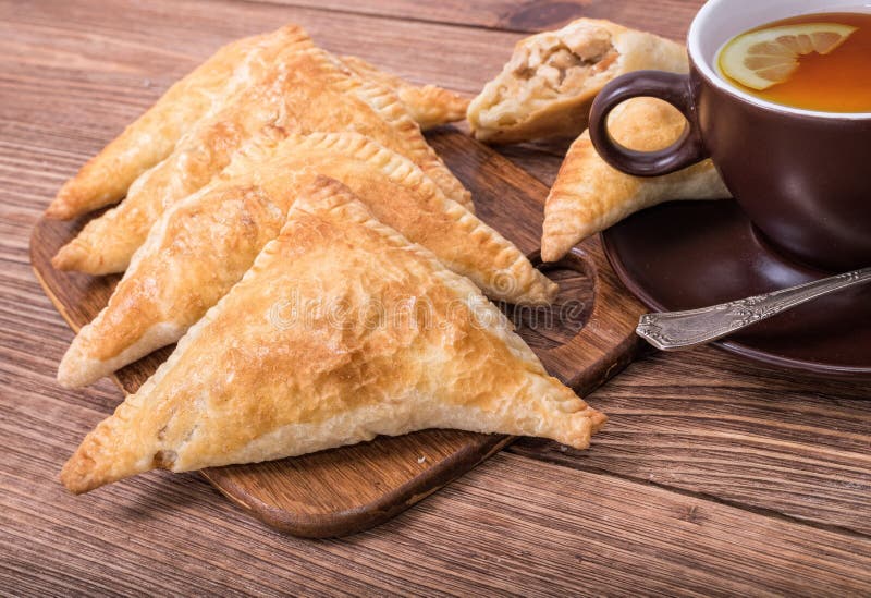 Triangle Meat Pies with Cup of Tea . Stock Photo - Image of elegant ...
