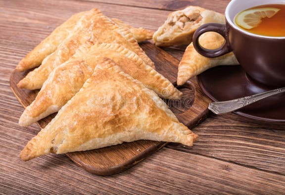 Triangle Meat Pies with Cup of Tea . Stock Photo - Image of elegant ...