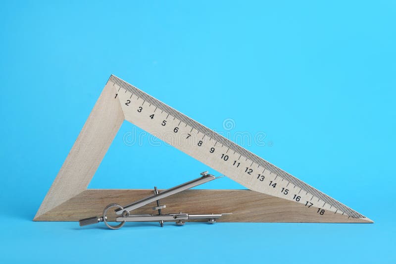Triangle Ruler and Compass on Light Blue Background Stock Image - Image ...