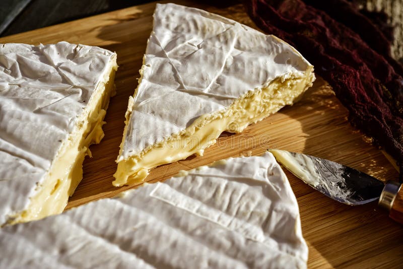 Triangle Wedge of Brie Cheese Cut from Whole Round Stock Image - Image ...