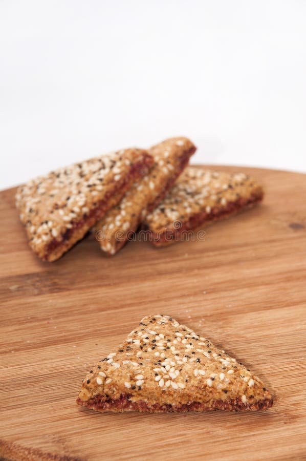 The Triangular Cookies with Cherries on a Kitchen Wooden Board Stock ...