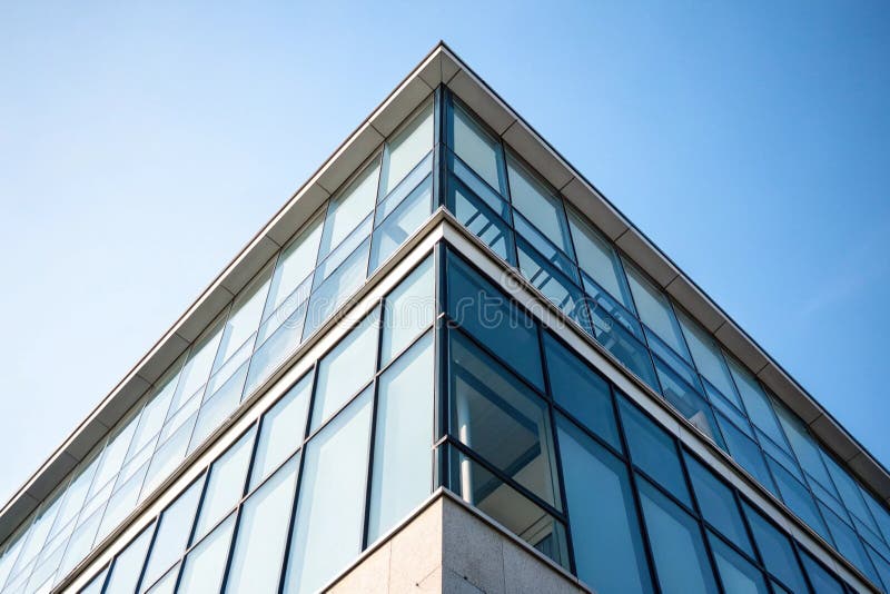 Triangular Corner of a Glass Building Against a Blue Sky. Minimalistic ...