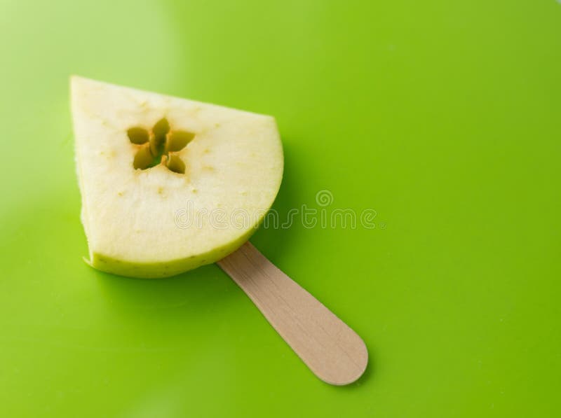 Triangular Piece of Apple on an Ice Cream Stick, Side View Stock Photo ...