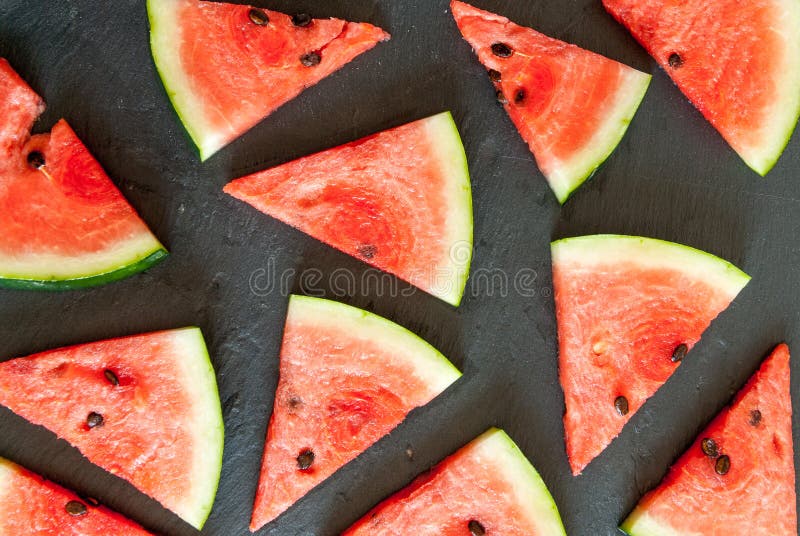 Triangular Pieces of Water Melon Spread on Black Stock Photo - Image of ...
