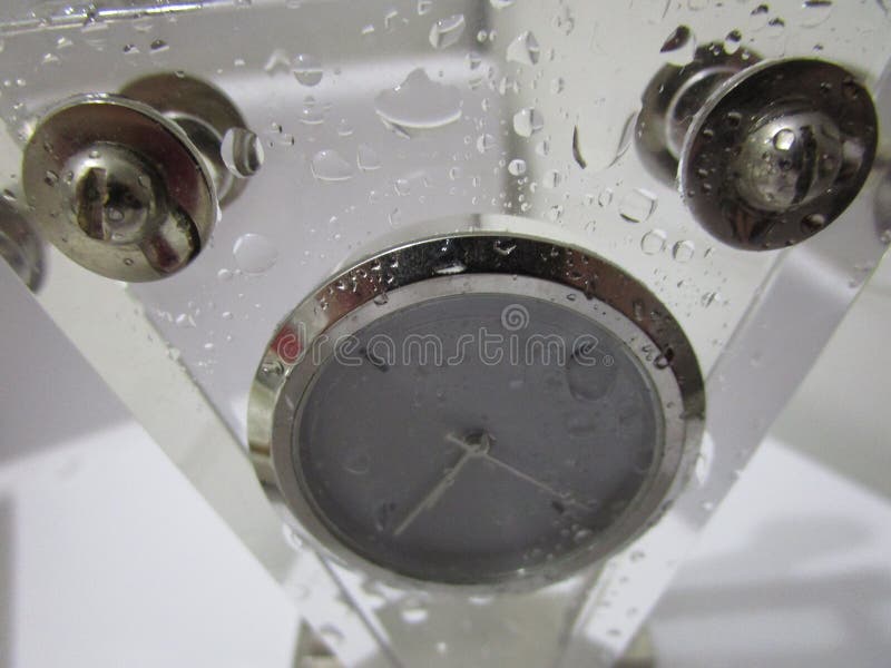 Triangular Prism Desk Clock Wet with Water Droplets. Stock Photo ...