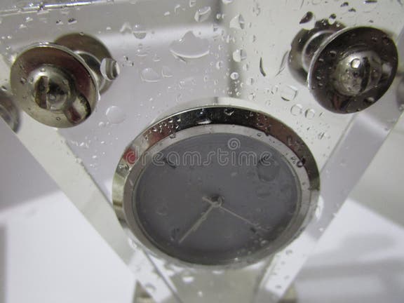 Triangular Prism Desk Clock Wet with Water Droplets. Stock Image ...