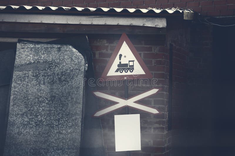 Triangular Railway Train Sign with Black White Plate Near Old Building ...