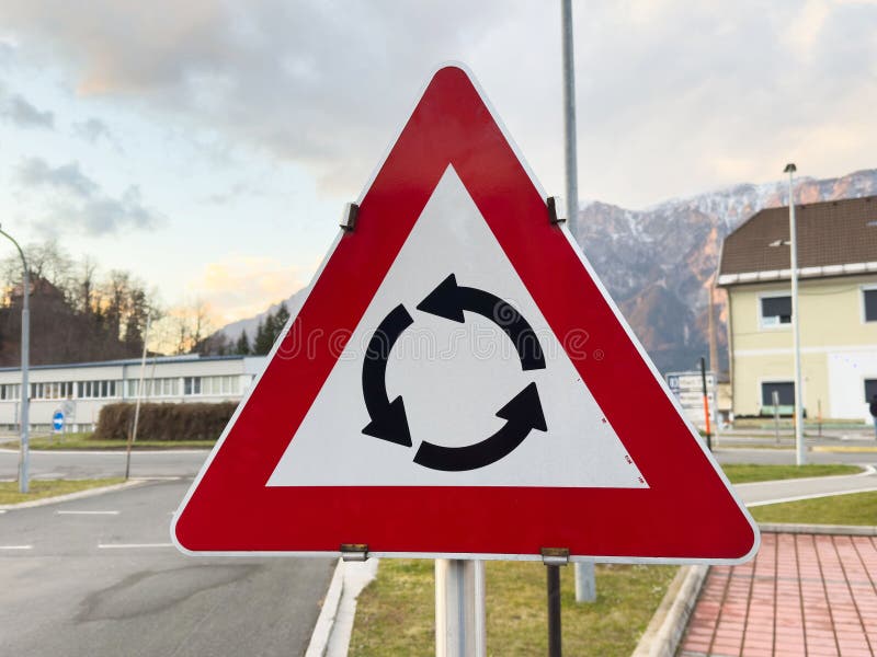 Triangular Red and White Roundabout Traffic Sign on Roadside with ...