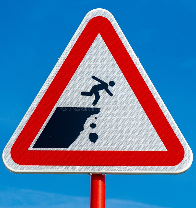 Triangular Road Sign of Danger of Person Falling on Cliff Under Blue ...