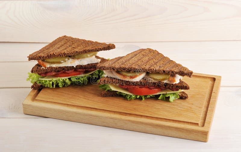 Triangular Sandwich on a Wooden Board Stock Photo - Image of dinner ...
