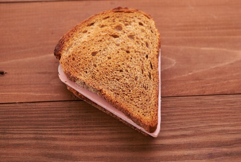 Triangular Sandwiches on Wooden Table Stock Photo - Image of snack ...