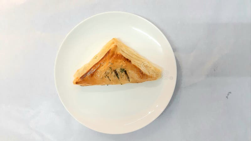Triangular Shaped Puff Pastry Bread on a Clean White Plate Stock Photo ...