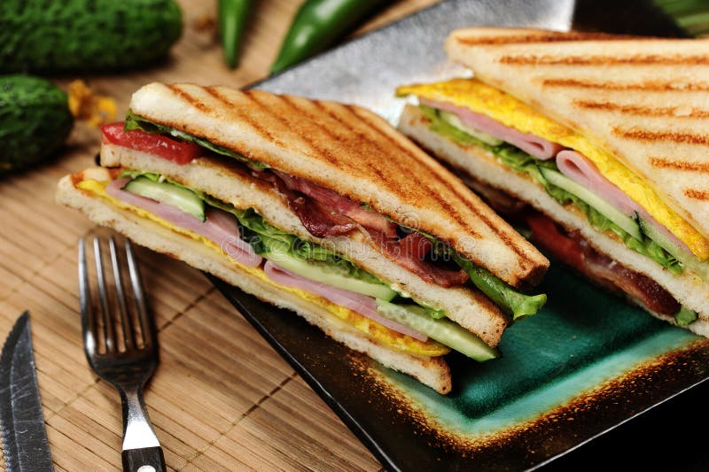 Triangular Shaped Sandwiches with Ham and Omelet on a Plate Stock Image ...