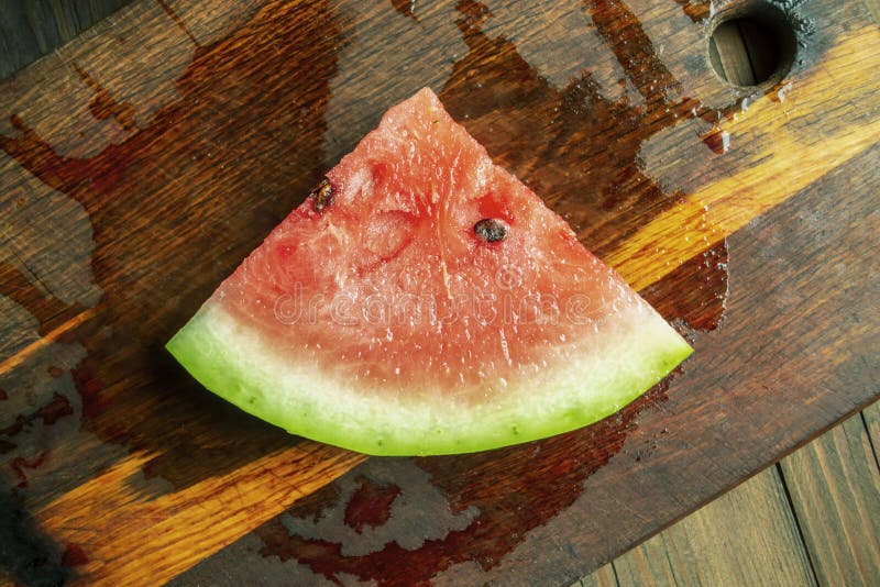 A Triangular Slice of Watermelon on a Wooden Table. Beautiful Slice of ...
