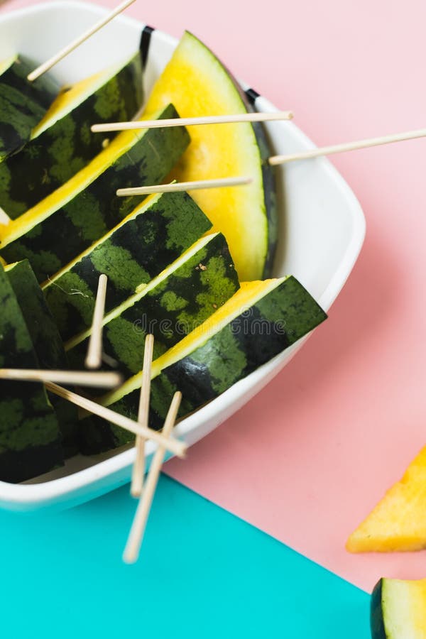 Triangular Slices of Ice Cream on a Stick of Ripe Yellow Watermelon in ...