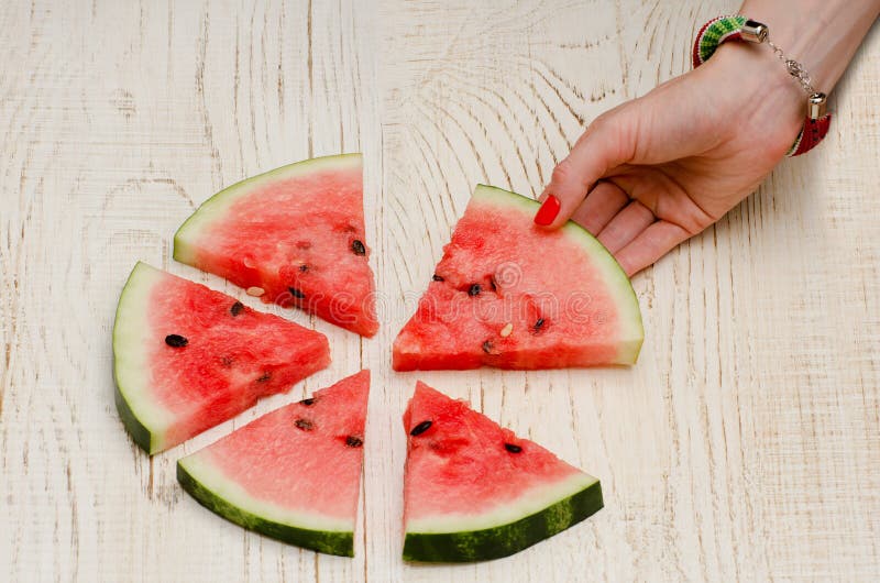 Triangular Slices of Watermelon Lying on a Circle a Female Hand Takes a ...