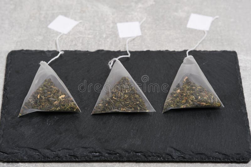 Triangular Teabag with Tea on a Slate. Stock Photo - Image of package ...