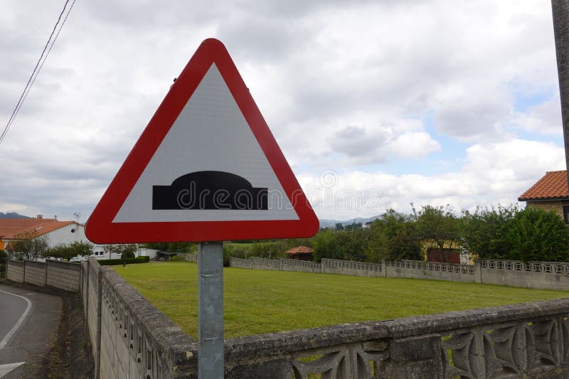 A Triangular Warning Sign for a Speed Bump is Positioned Near a ...