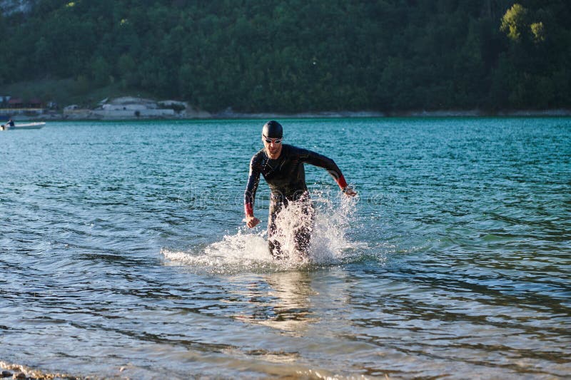 Triathlon Athlete Starting Swimming Training on Lake Stock Photo ...