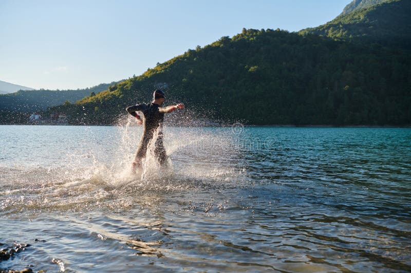 Triathlon Athlete Starting Swimming Training on Lake Stock Image ...
