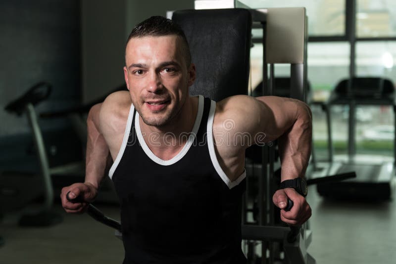 Triceps Workout on Machine stock photo. Image of build - 76032812