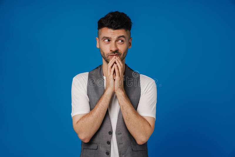 Tricky Man with Clasping Hands Isolated Over Blue Wall Stock Photo ...