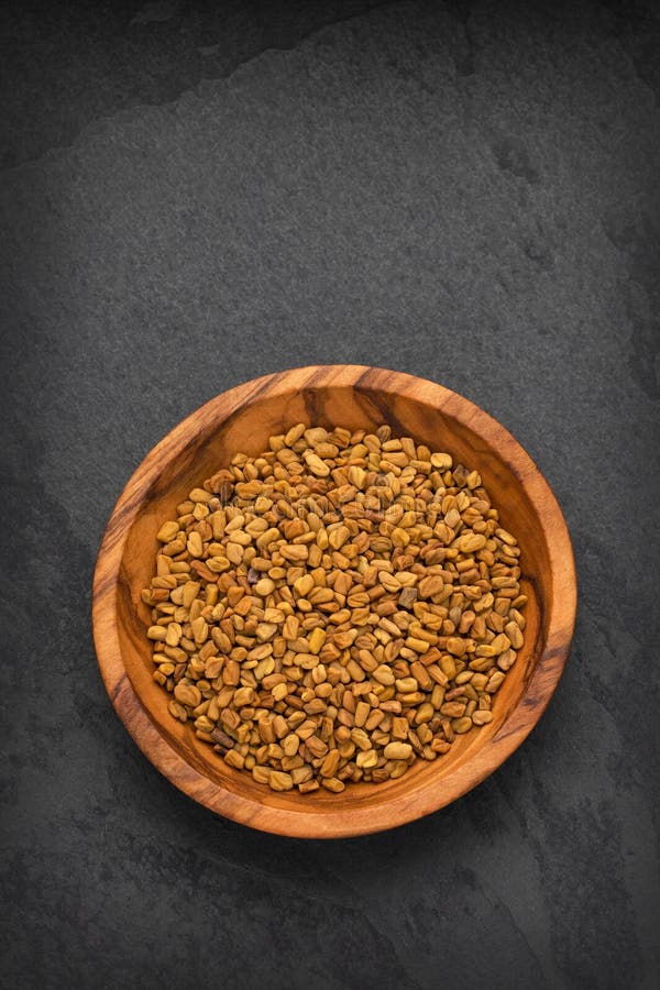 Trigonella Foenum-graecum - Dried Organic Fenugreek Seeds in the Spoon ... Trigonella Foenum-graecum - Dried Organic Fenugreek Seeds in the Spoon ...