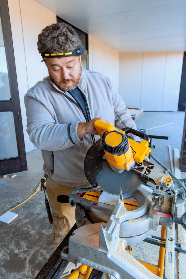 Trim Worker Cuts Wooden Moldings on a Chop Saw Stock Photo - Image of ...