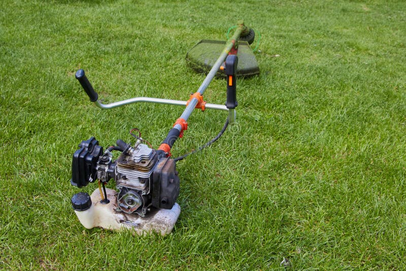 Trimmer Broken on the Grass,Petrol Trimmer Disassembled on the Grass ...