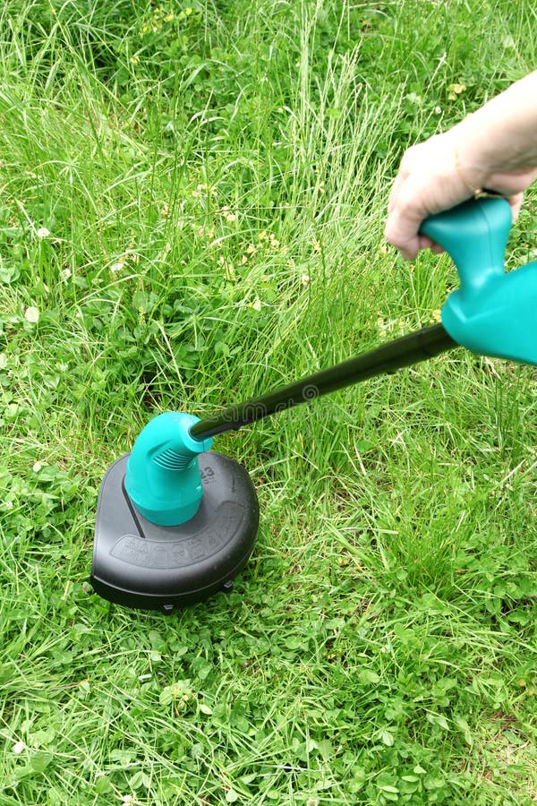 Trimming Grass with an Electric Lawn Trimmer Stock Photo - Image of ...